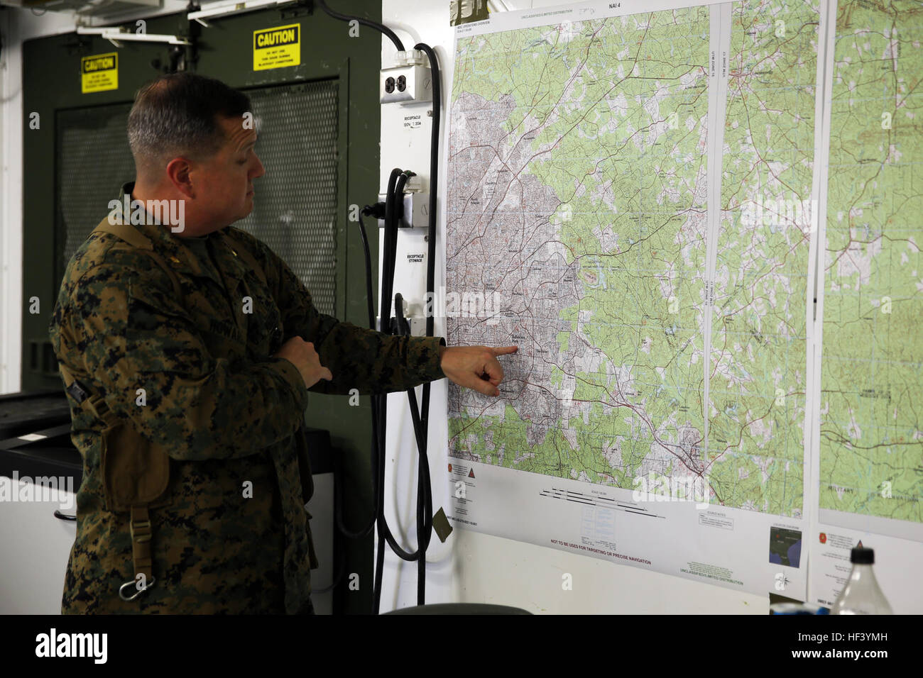 Maj. Jonathan C. Howard reviews a map during the Marine Expeditionary ...