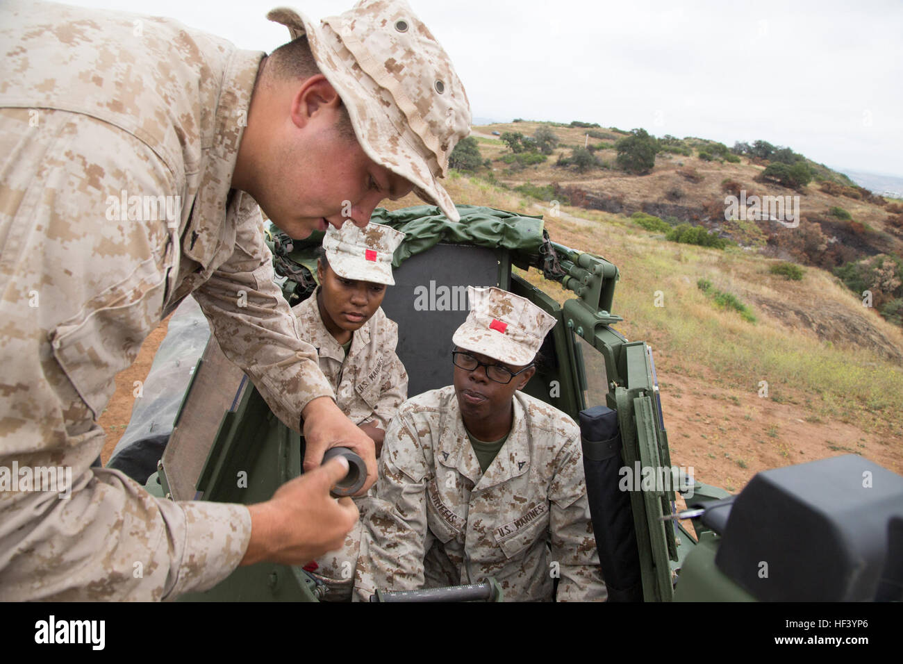 Lance Cpl. Sean Sims shows Lance Cpl. Robtavia Almore (back, left) and ...