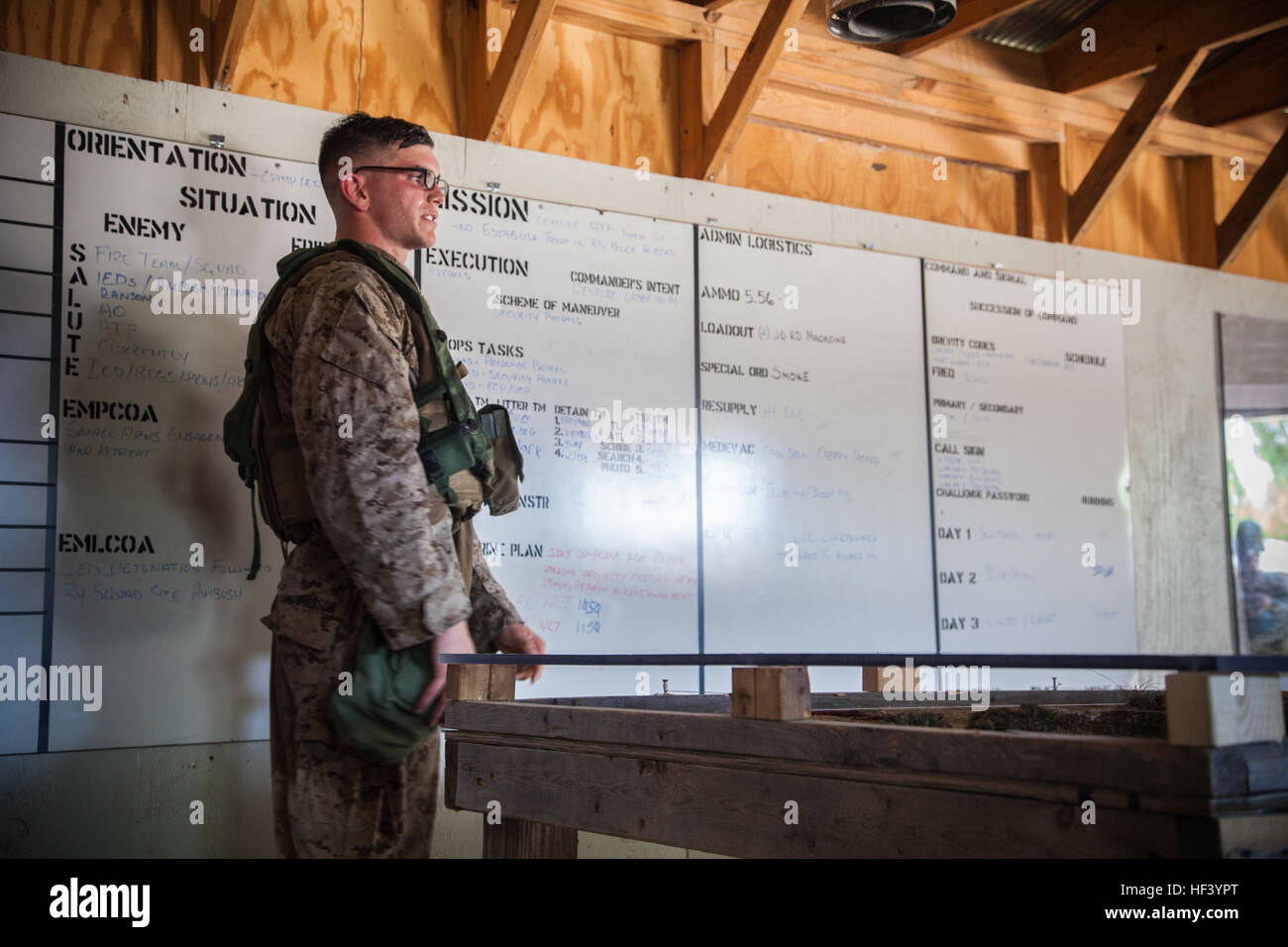 A U.S. Marine attending the Military Police Basic Course, gives a ...