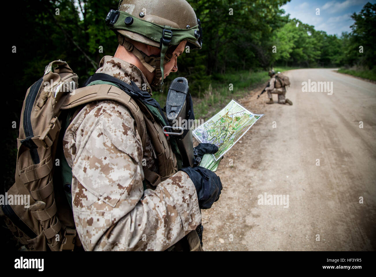 A U.S. Marine attending the Military Police Basic Course, reviews a ...