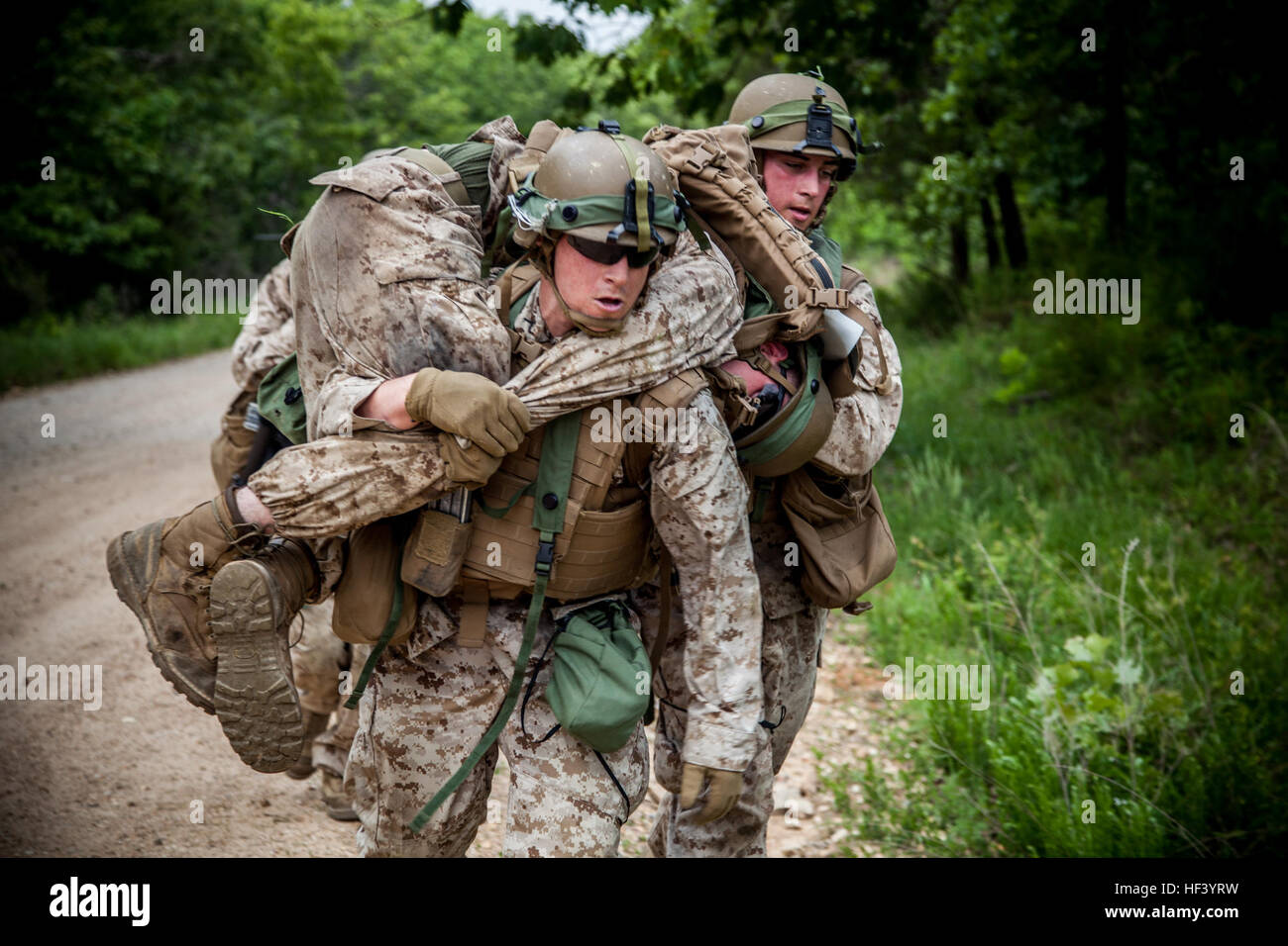 A Marine attending the Military Police Basic Course carries a simulated ...