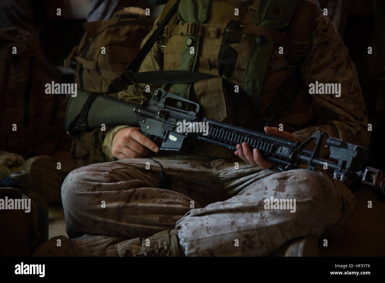 A U.S. Marine attending the Military Police Basic Course cradles his ...