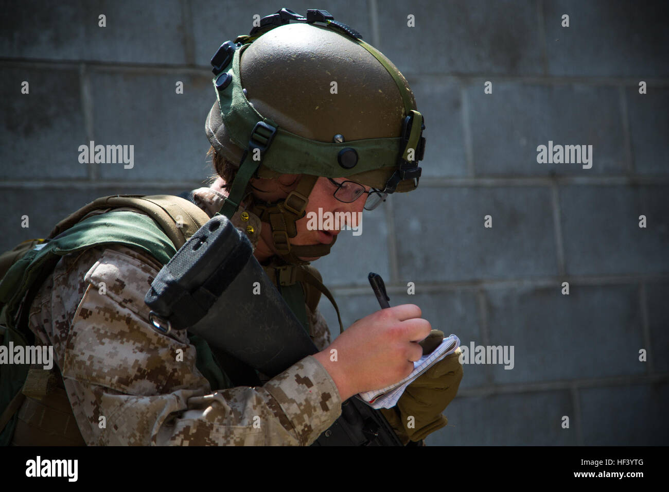 A U.S. Marine attending the Military Police Basic Course, takes notes ...
