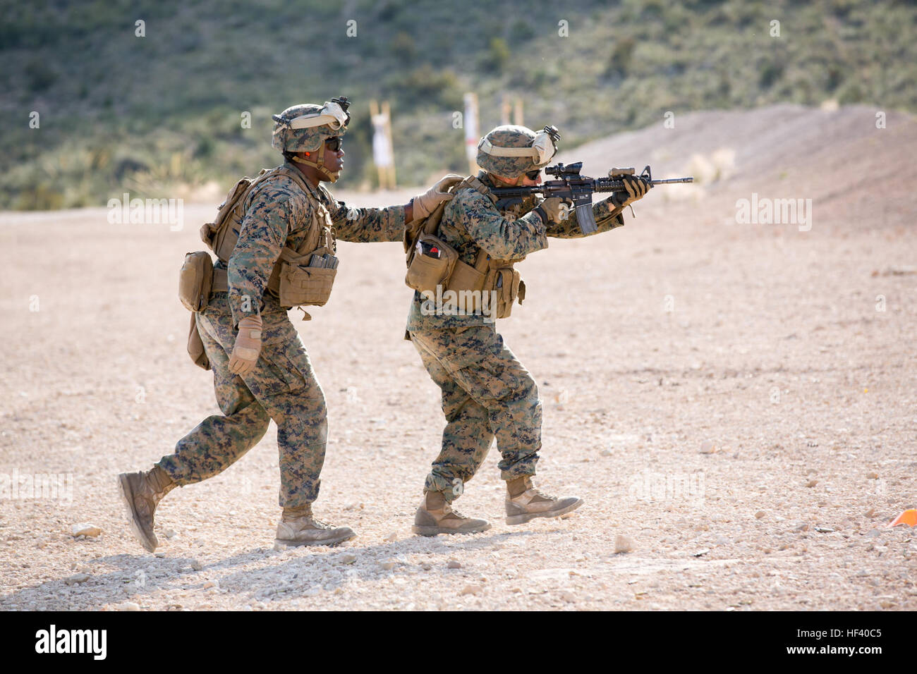 U.S. Marine Corps Cpl. Matiyes Kinker, (left), a squad leader guides ...