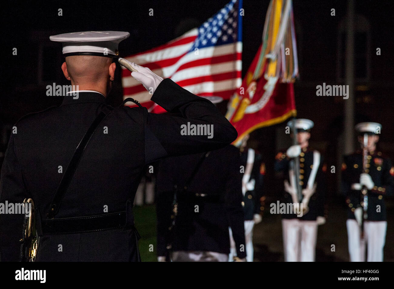 A U.S. Marine salutes the Colors during an evening parade at Marine ...