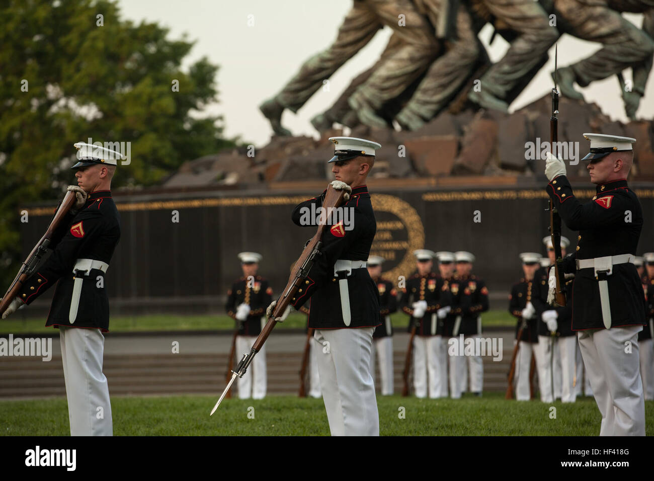 U.S. Marines with the Silent Drill Platoon perform during a sunset ...