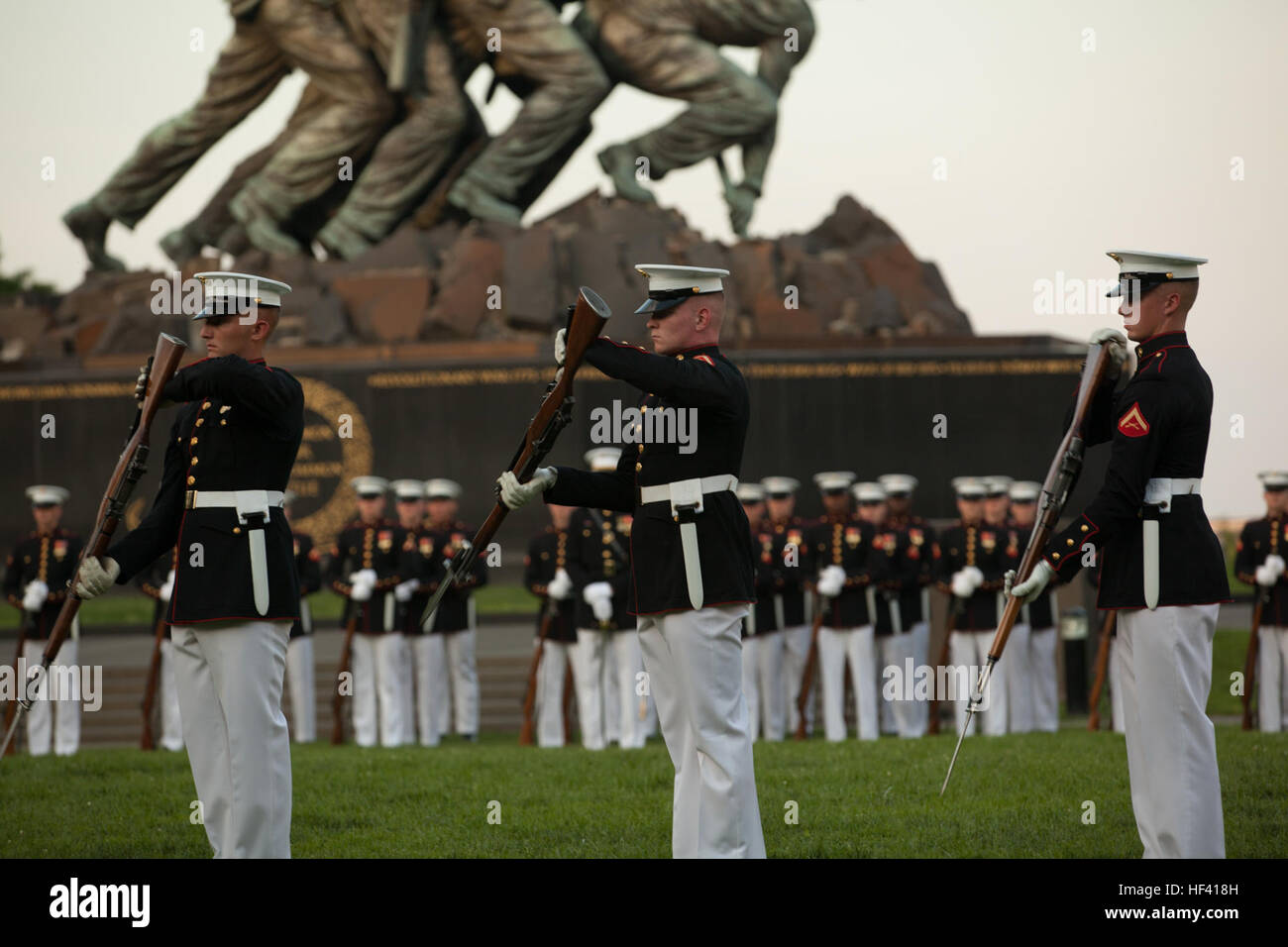 U.S. Marines with the Silent Drill Platoon perform during a sunset ...