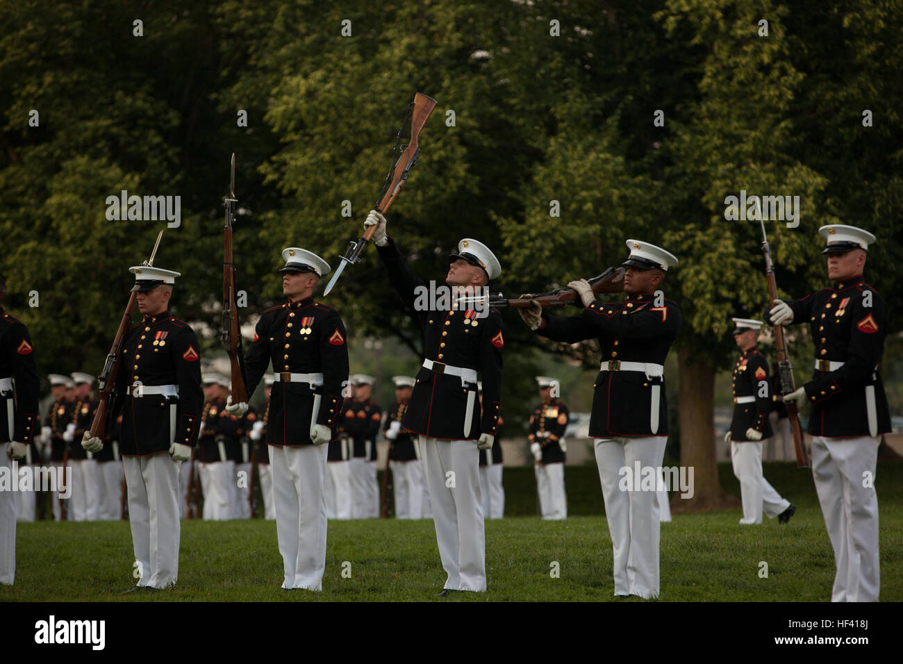 U.S. Marines with the Silent Drill Platoon perform during a sunset ...