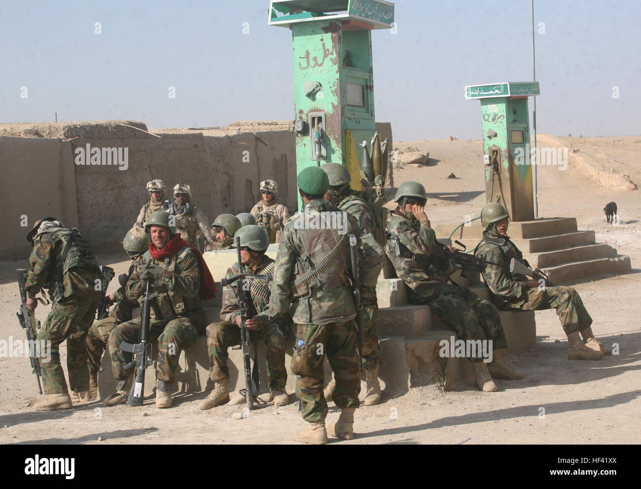 Soldiers from the Afghan National Army relax after a patrol in Marjah ...