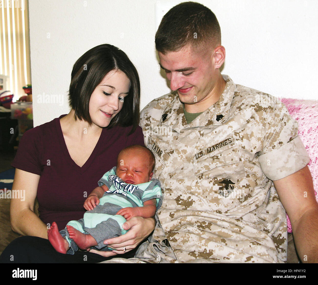 Sgt. Matthew Tatar and his wife Tiffany in their home with their two ...