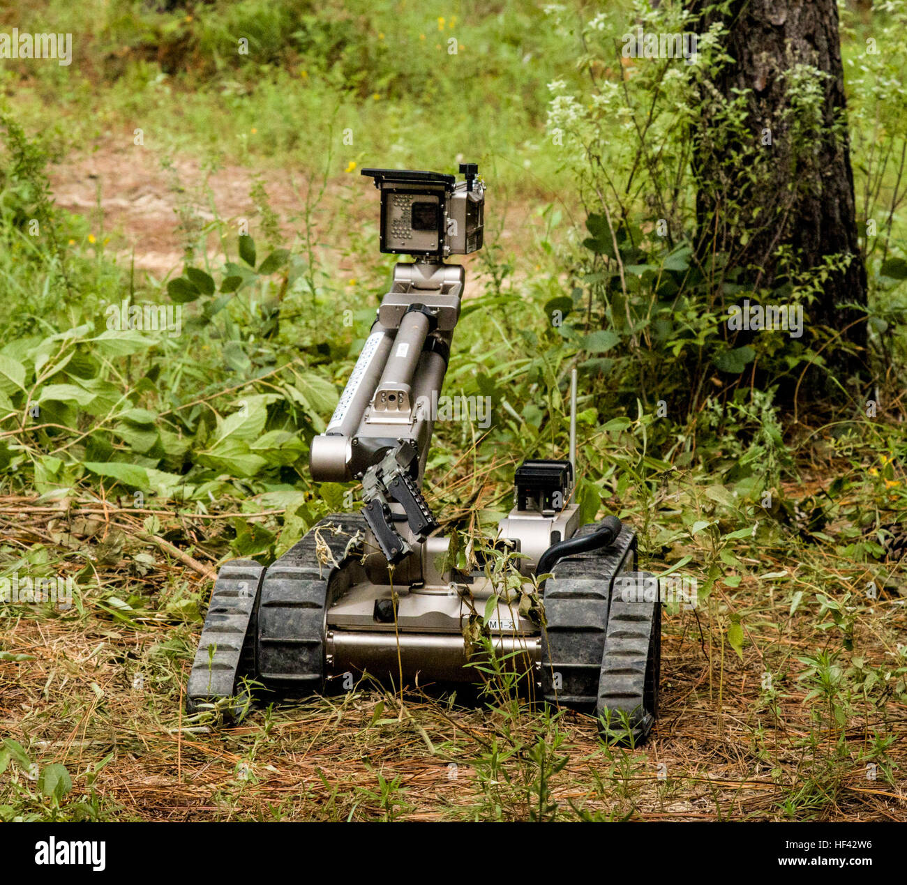 An Explosive Ordnance Disposal (EOD) robot lifts its camera to view ...