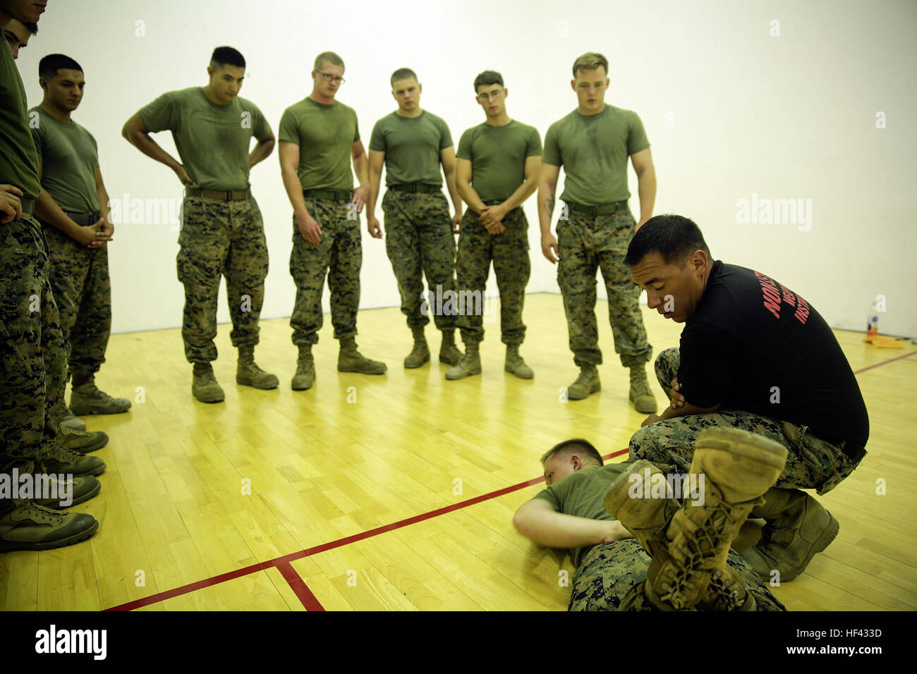 U.S. Marine Corps Staff Sgt. Joseph Mendoza, left, a non-lethal weapons ...