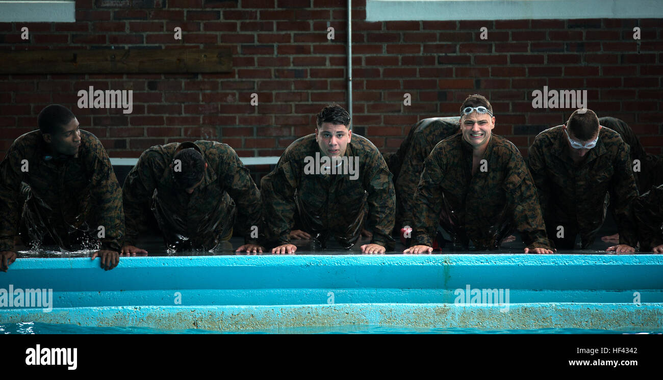 Marines do push-ups in a line poolside during advanced water survival ...