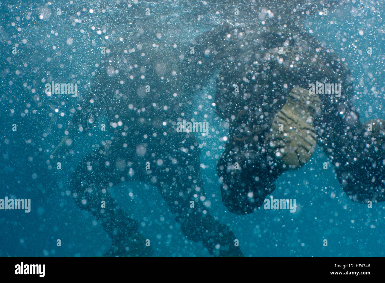 Marines swim through the water performing mock rescues during advanced ...