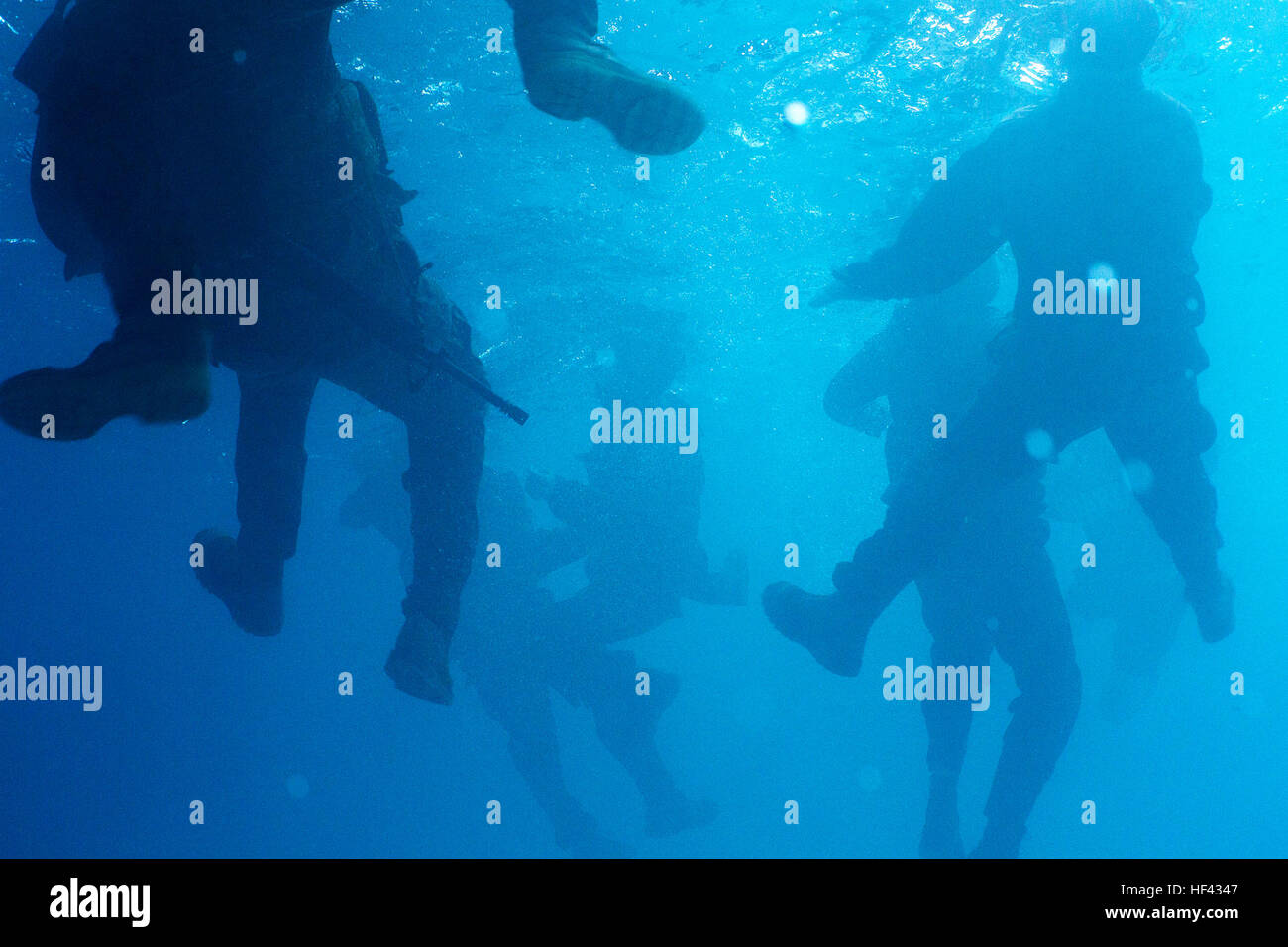 Marines swim through the water performing mock rescues during advanced ...