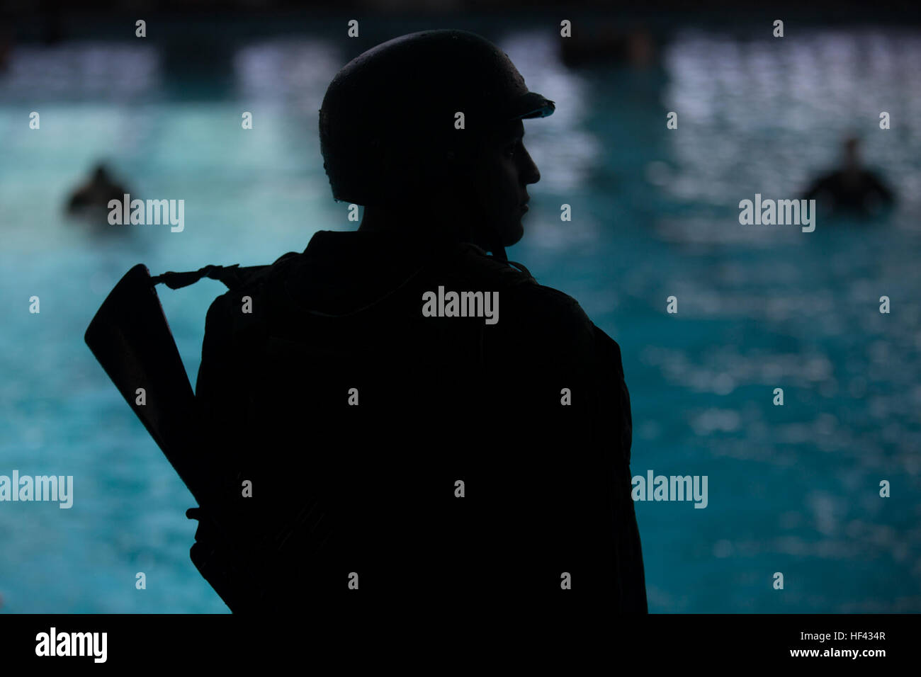 A Marine waits to enter the pool during advance water survival training ...