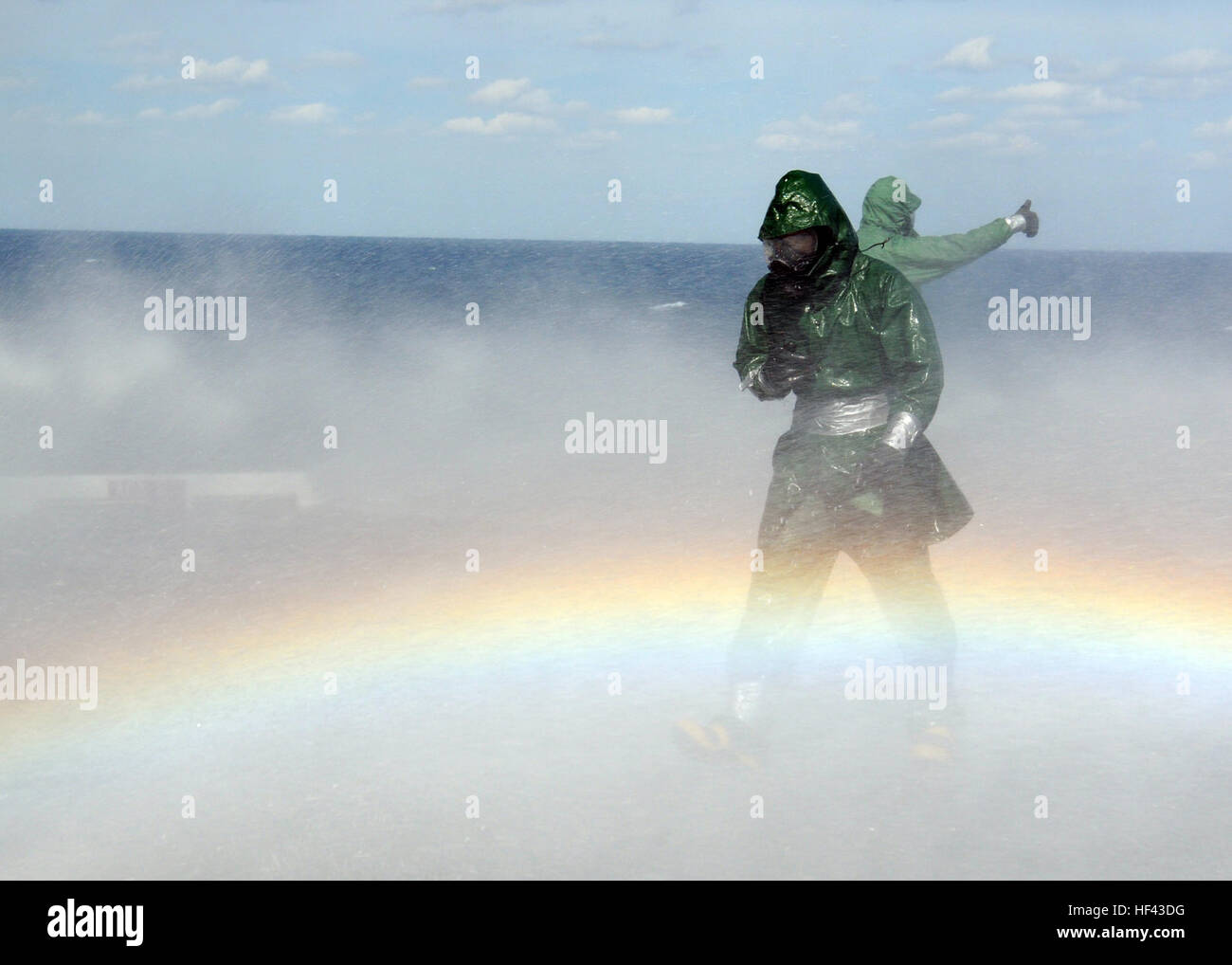 A Sailor conducts a maintenance check on the flight deck sprinklers ...