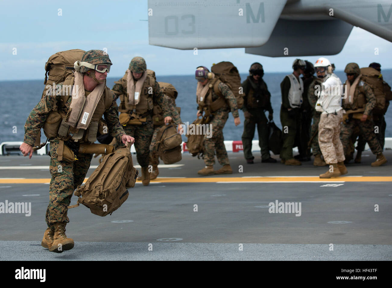 Marines exit a MV-22 Osprey with Marine Medium Tiltrotor Squadron 365 ...