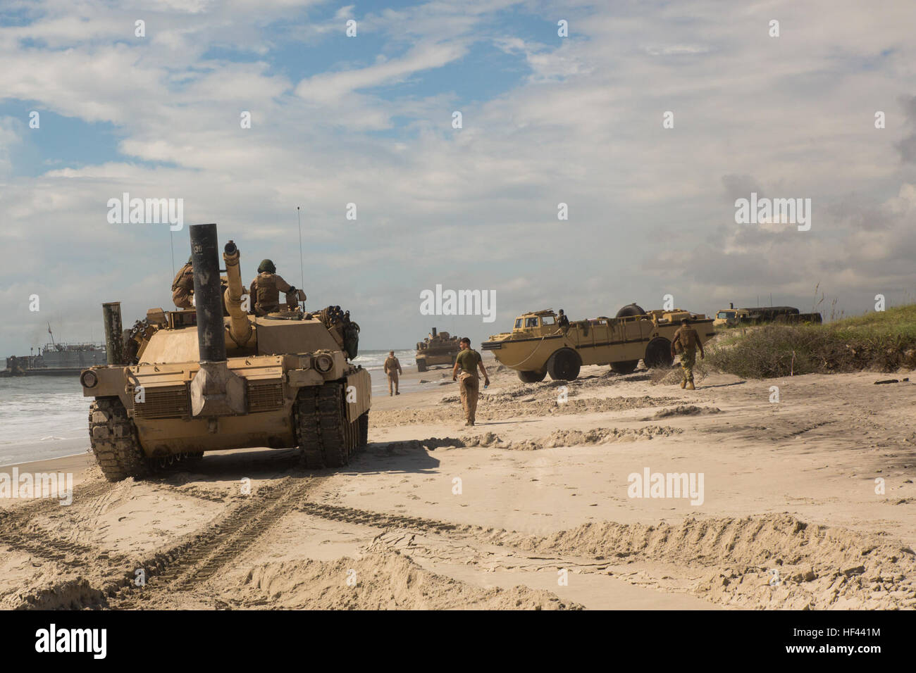 Marines maneuver a M1A1 Main Battle Tank across the beach prior to ...