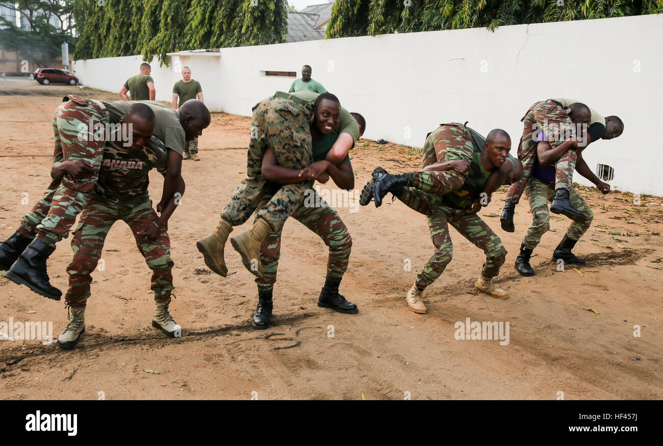 Sailors with the Benin Navy conduct buddy squats during a physical ...