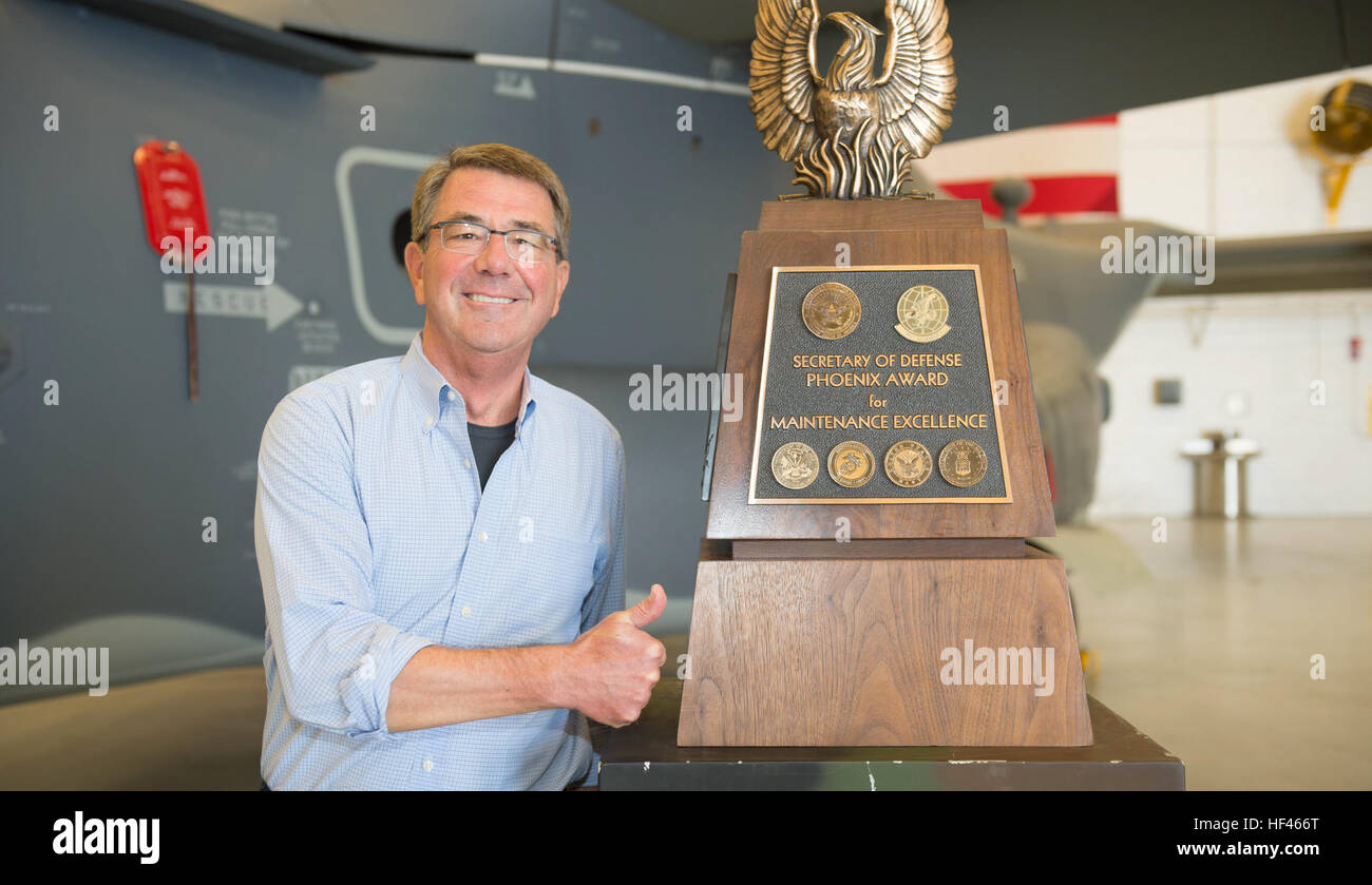 Secretary of Defense Ash Carter stands with the Phoenix Award for ...