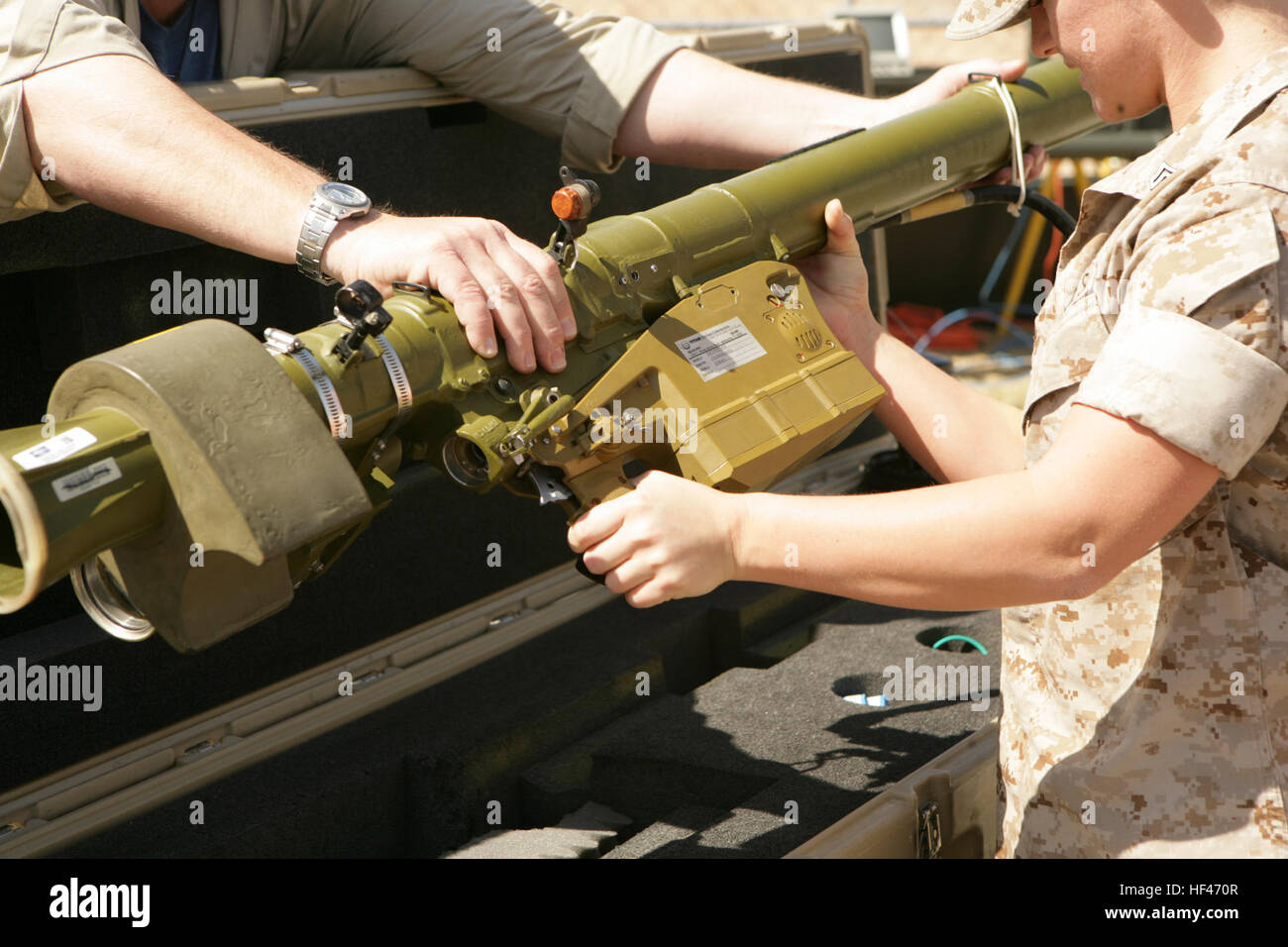 A U.S. Marine Corps corporal, right, sets down a man-portable air ...