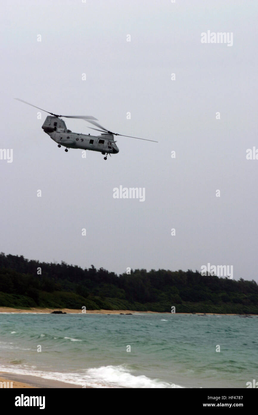 A CH-46 Sea Knight helicopter loaded with scout swimmers heads out over ...