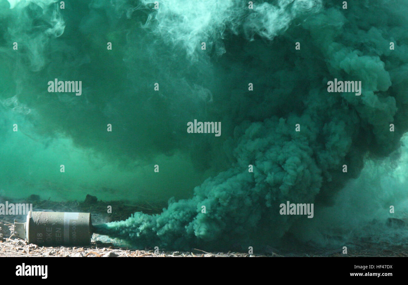 Smoke billows from an M18 green smoke hand grenade during a U.S. Marine ...