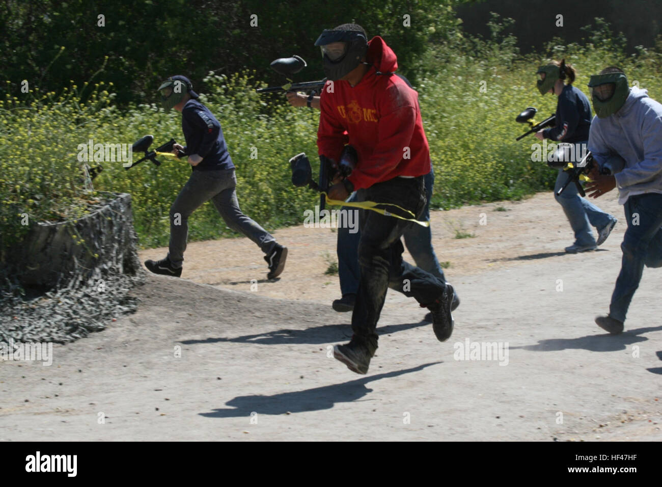 Marines, Sailors and their family members rush for cover as a paintball ...