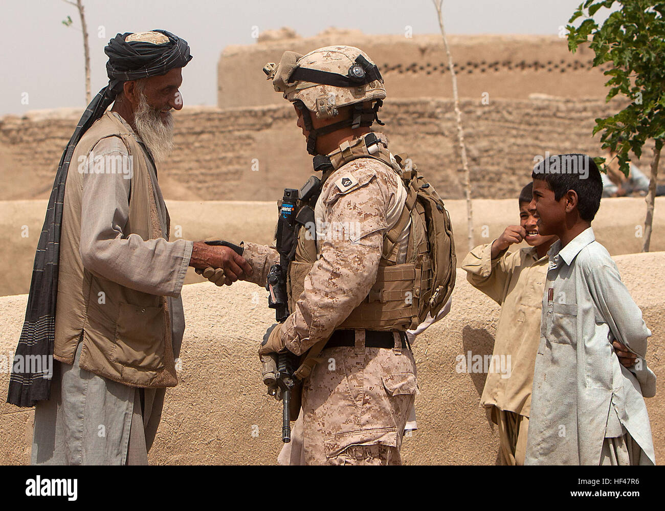 Local children look on as Gunnery Sgt. Carlos Aguilera, the platoon ...