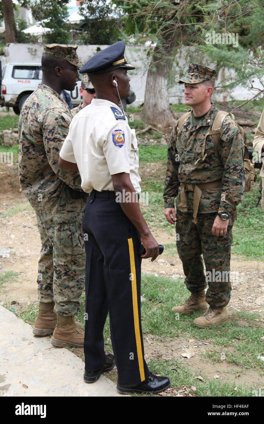 CaptionJean Moise, chief of Port-de-Paix, Haiti National Police, speaks with Lt. Col. Chris S ...