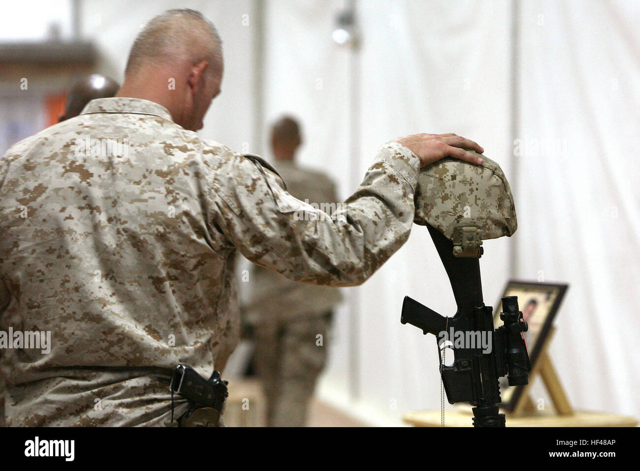A Marine pays his final respects to Gunnery Sgt. Christopher Eastman ...