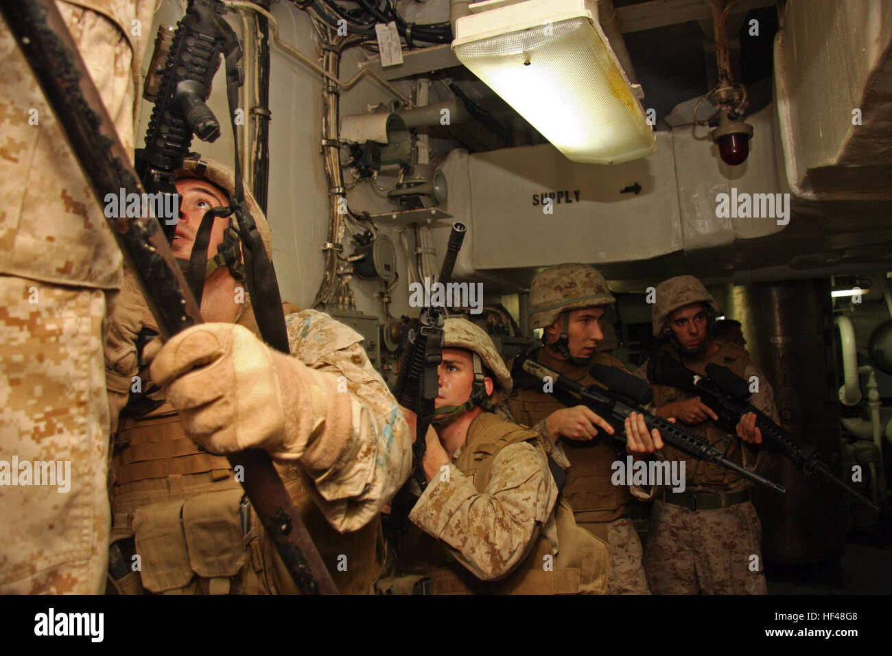 Corporals of the 24th Marine Expeditionary Unit storm a ladder well ...