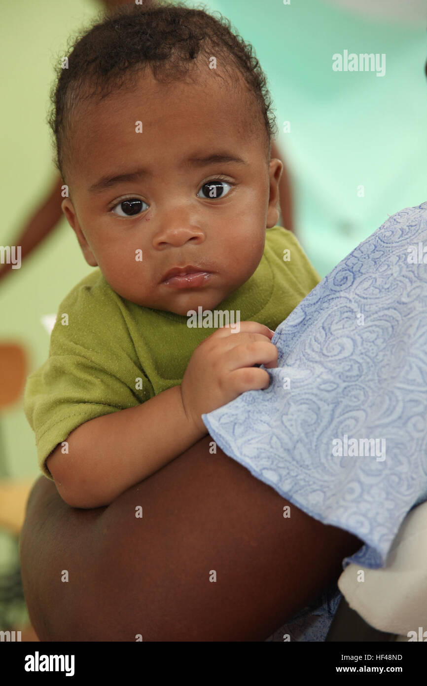 A Costa Rican baby waits with his mother for medical treatment in a ...