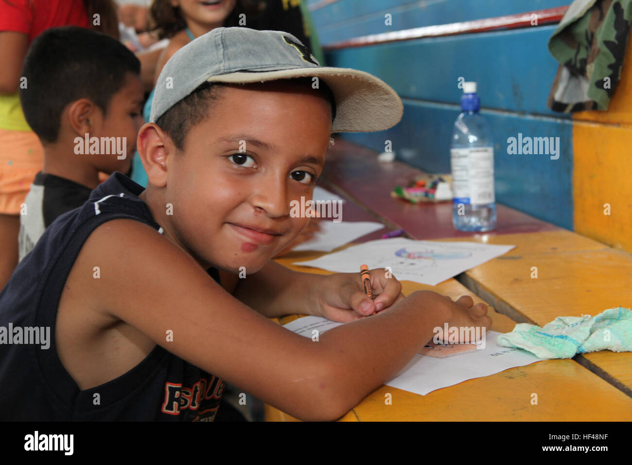 A Costa Rican child colors as he waits for medical treatment in a Costa ...