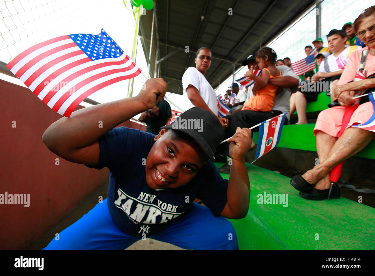 A Costa Rican child poses for a photo with American and Costa Rican ...
