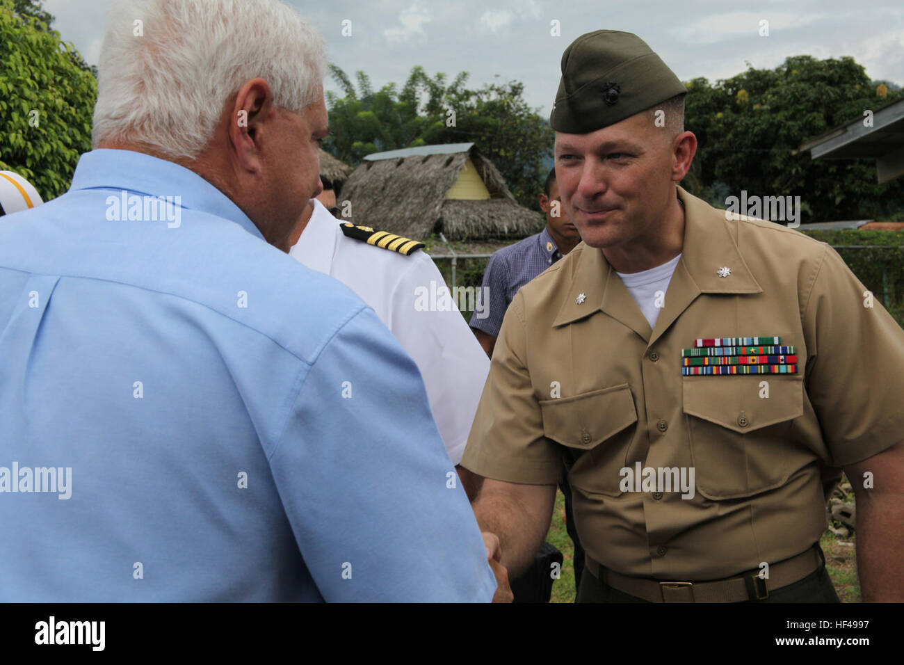 Panamanian President Ricardo Martinelli shakes hands with Lt. Col. Chris S. Richie, commanding ...
