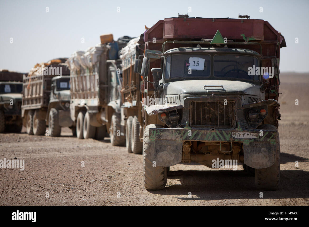 Afghan trucks line up as a convoy prepares to move in Helmand province ...