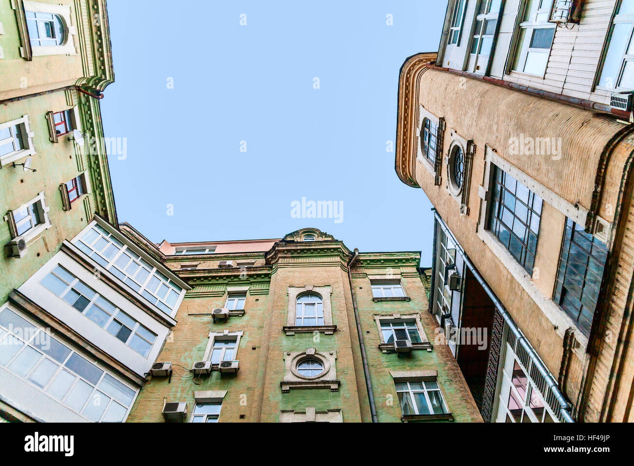 view from the bottom up at the sky, tall old houses, wells, balconies ...