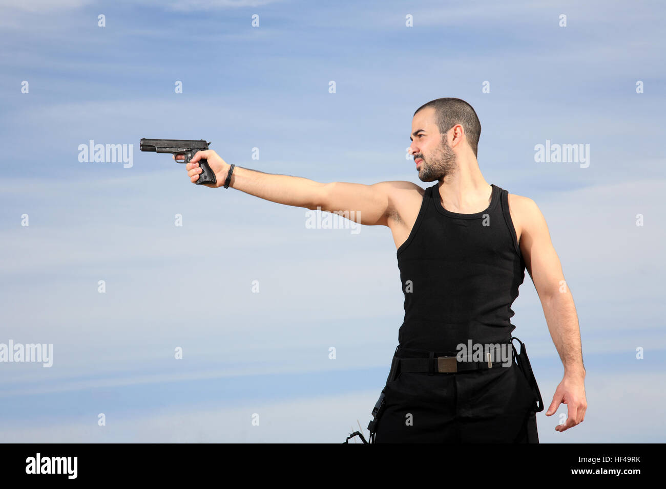 young man bodyguard with a gun outdoor Stock Photo - Alamy