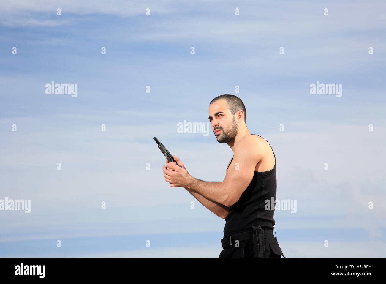 young man bodyguard with a gun outdoor Stock Photo - Alamy