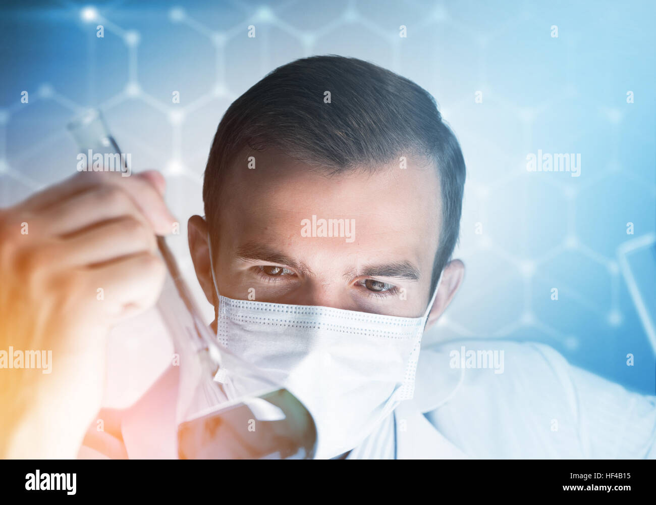 Portrait of concentrated male scientist working with reagents in ...