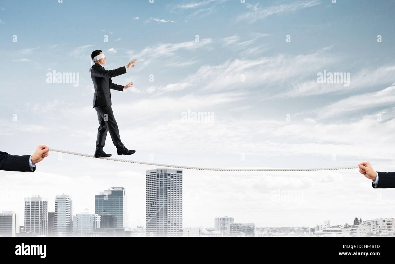 Business concept of risk support and assistance with man balancing on ...