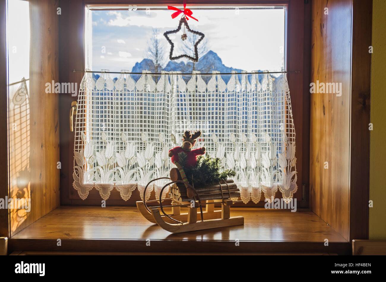 A window of an Alpine hut with some Christmas decorations Stock Photo ...