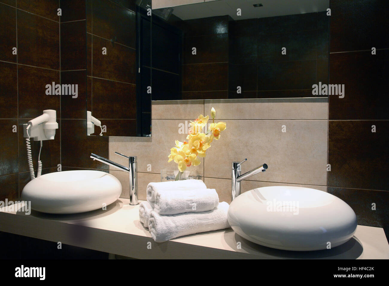 interior of a luxury bathroom with towels and flowers Stock Photo - Alamy