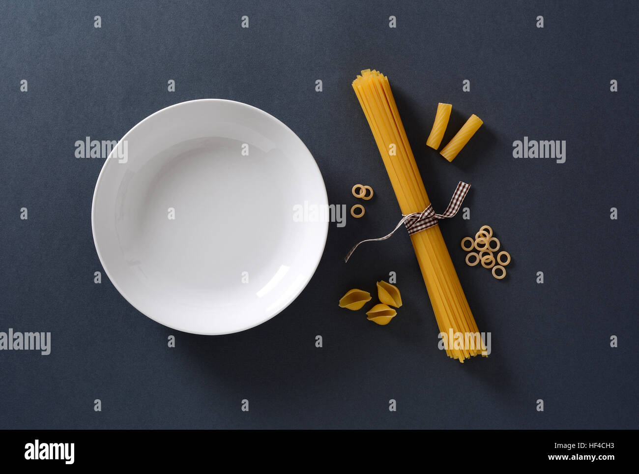 Italian pasta and empty plate Stock Photo - Alamy