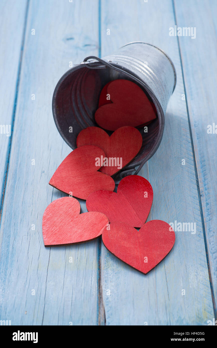 Metal bucket pouring red hearts Stock Photo - Alamy