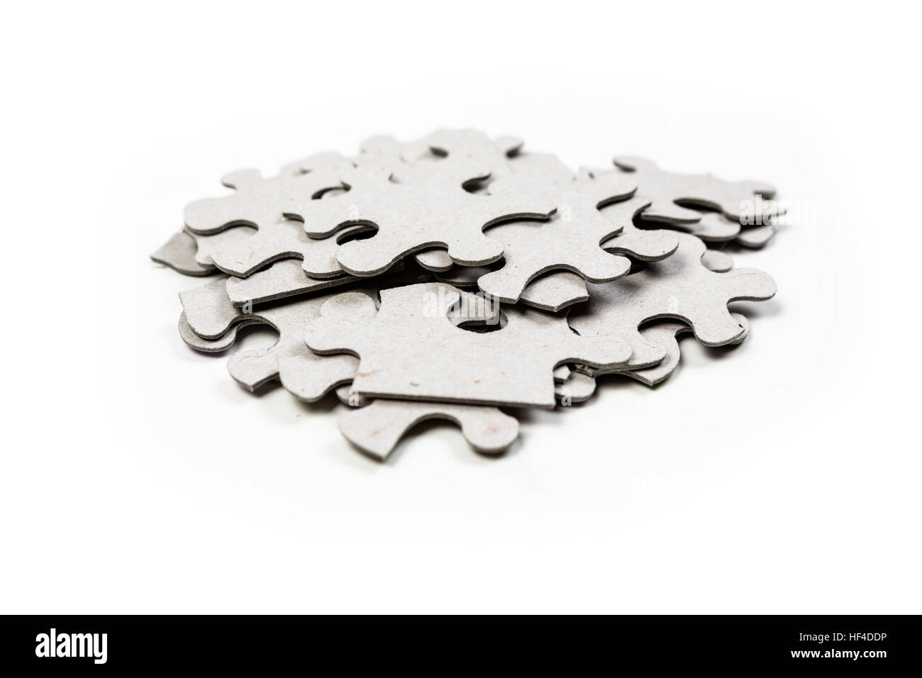 Pile of puzzle pieces isolated on white background Stock Photo - Alamy
