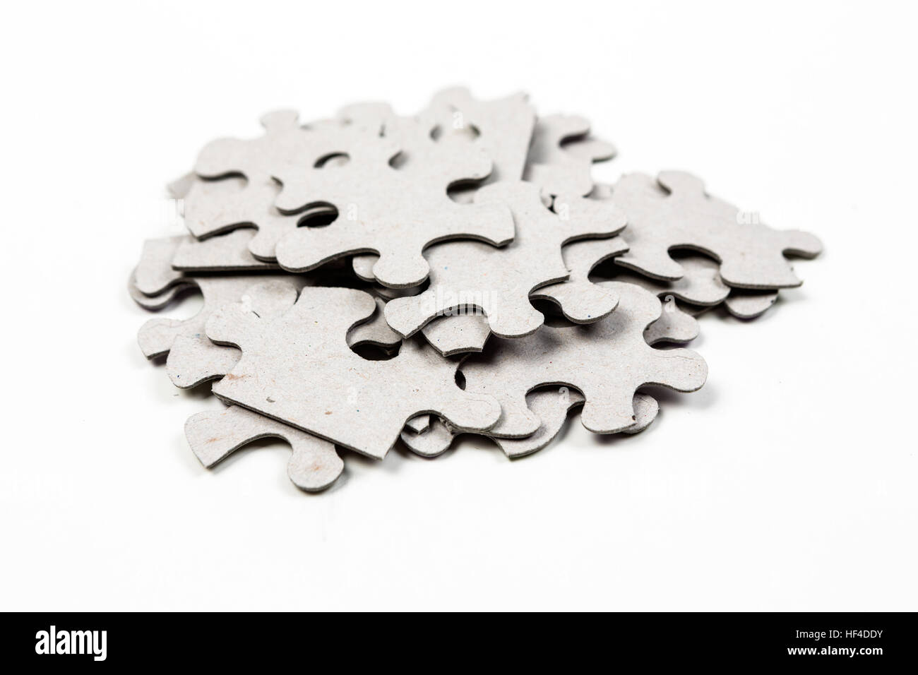 Pile of puzzle pieces isolated on white background Stock Photo - Alamy