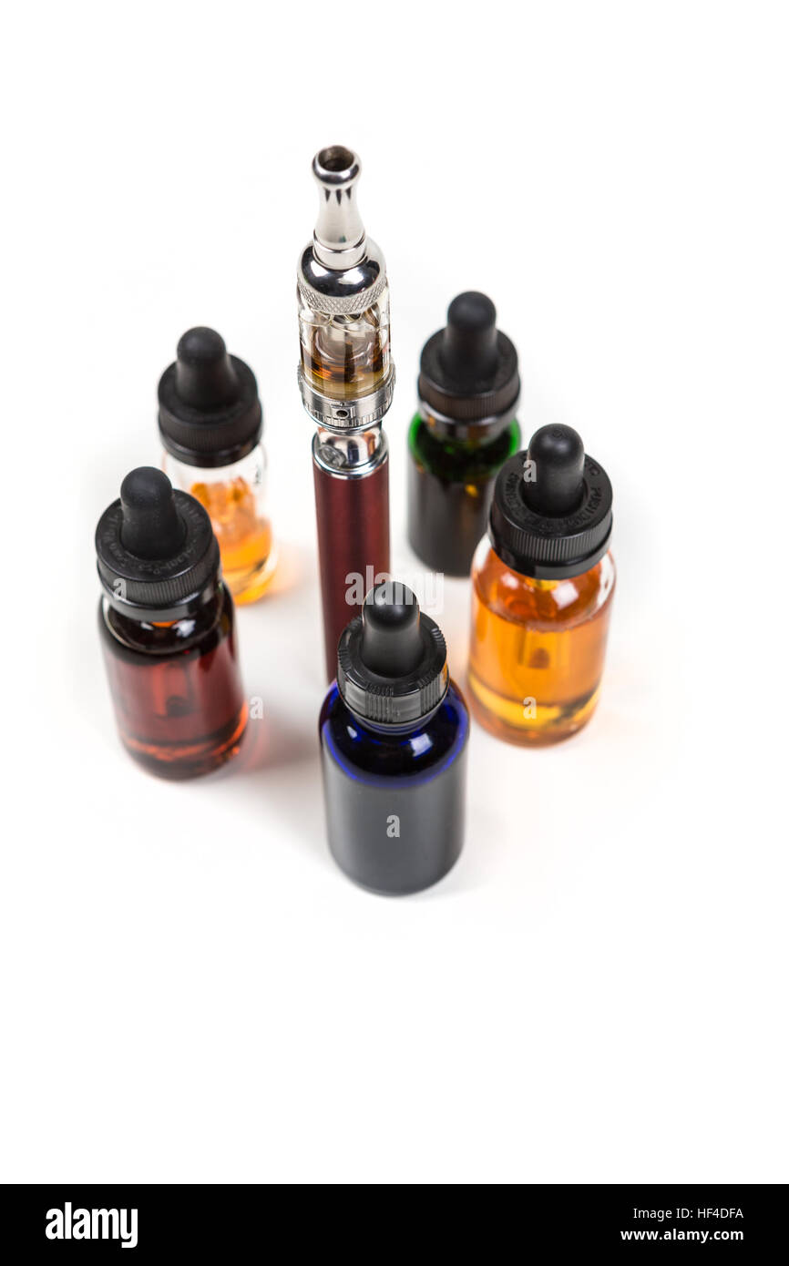Assorted flavors of vape juice and an ecigarette isolated on white ...